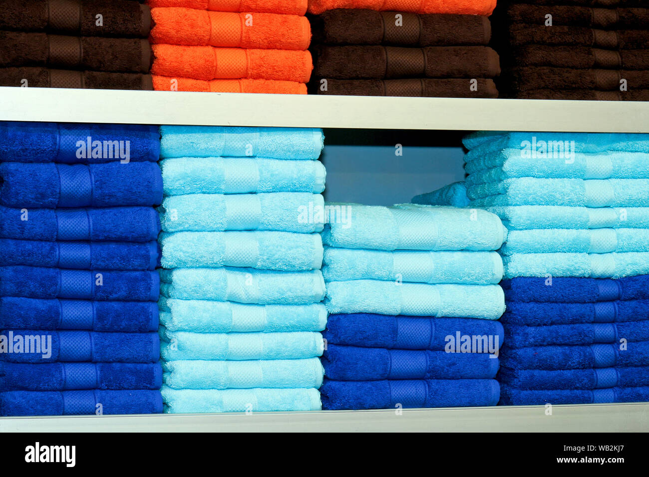 Big shelf with bunch of colorful towels Stock Photo - Alamy