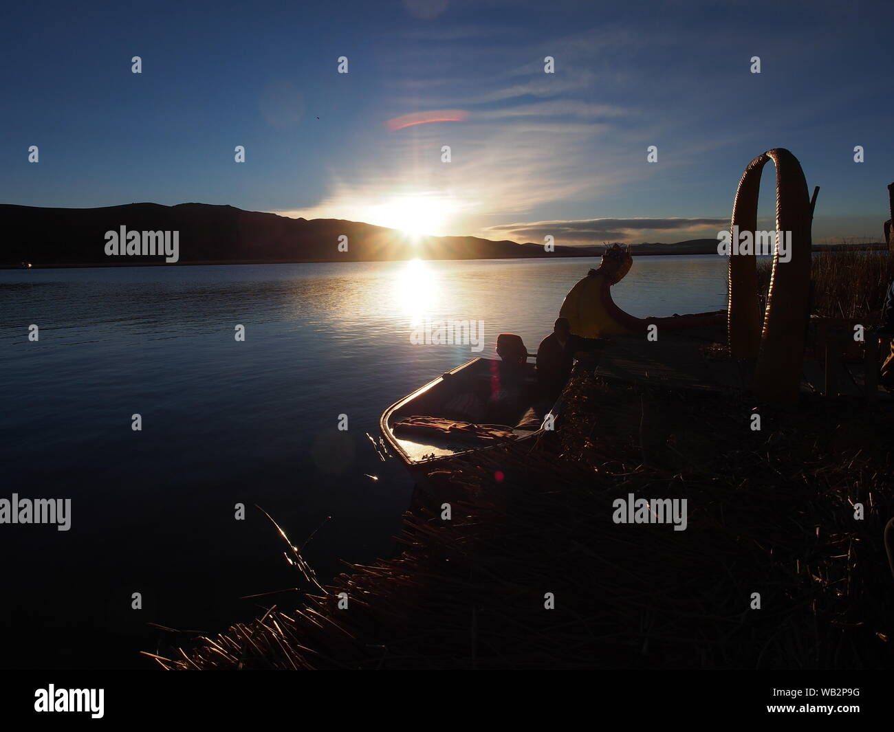 Sunset from a floating Uro island in titicaca lake. The Uru or Uros are ...