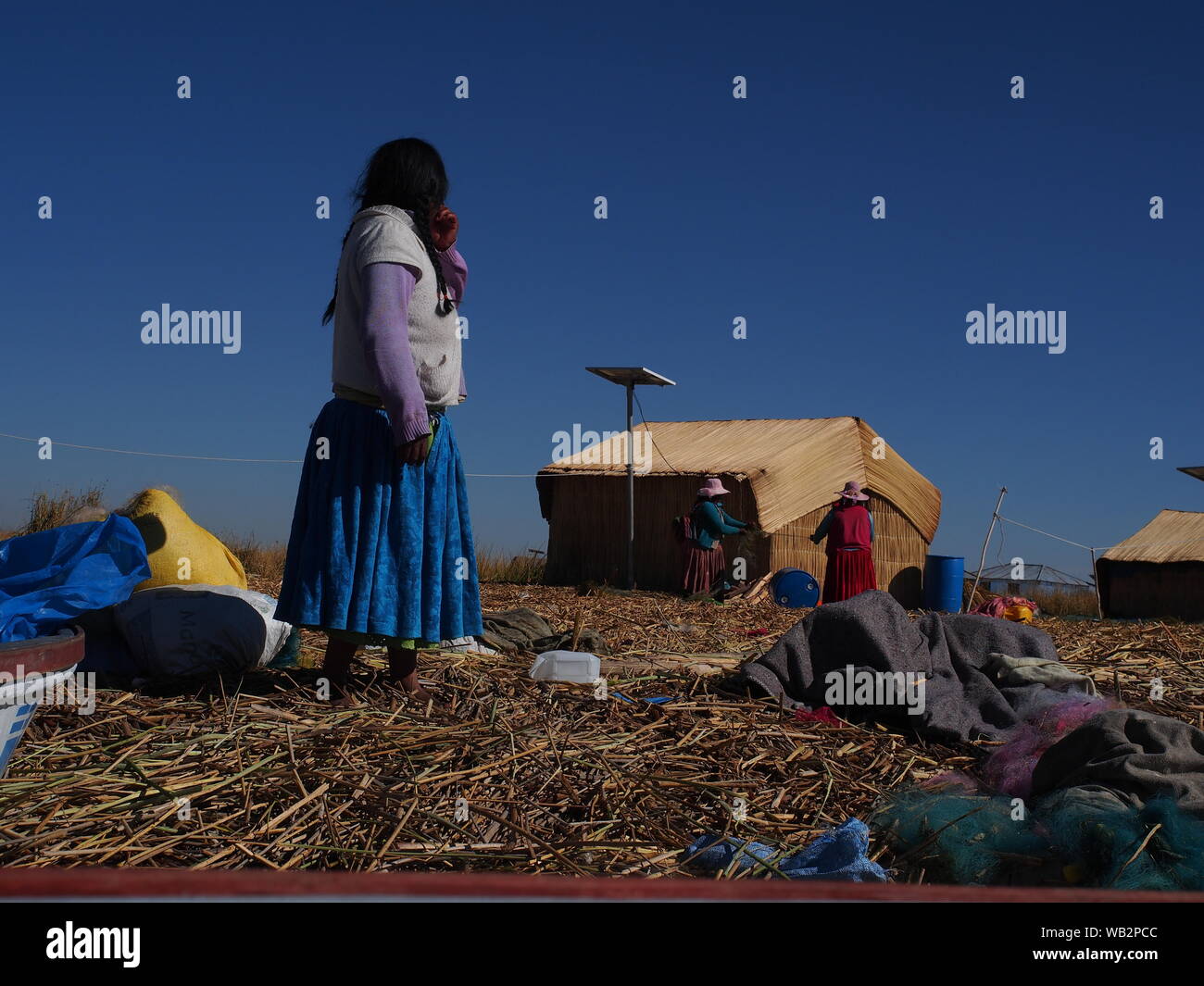 An Uro Indian woman standing up on Titinos Island. The Uru or Uros are ...