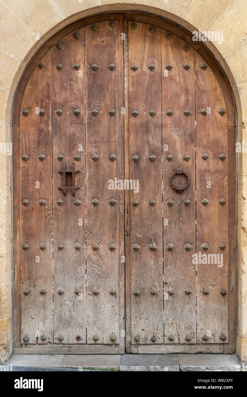 Ancient gate to the catholic spanish church with a window and a metal ...