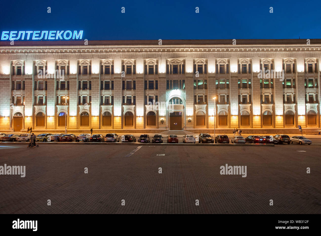 Night view of a building overlooking October Square in Minsk, Belarus ...
