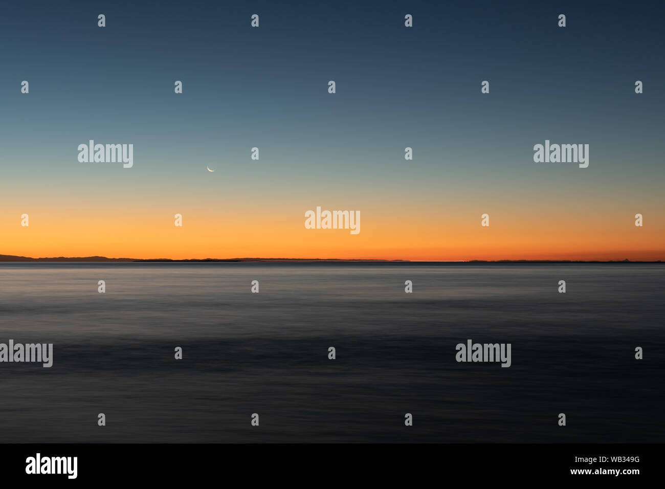 Crescent moon overlooking over the sunset Stock Photo - Alamy