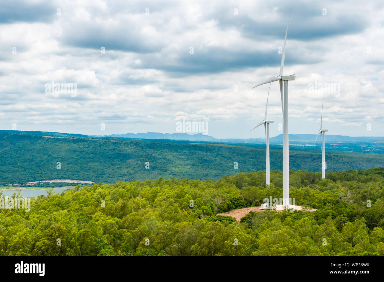 Wind energy turbines in the midst of nature, gorge and trees sky ...