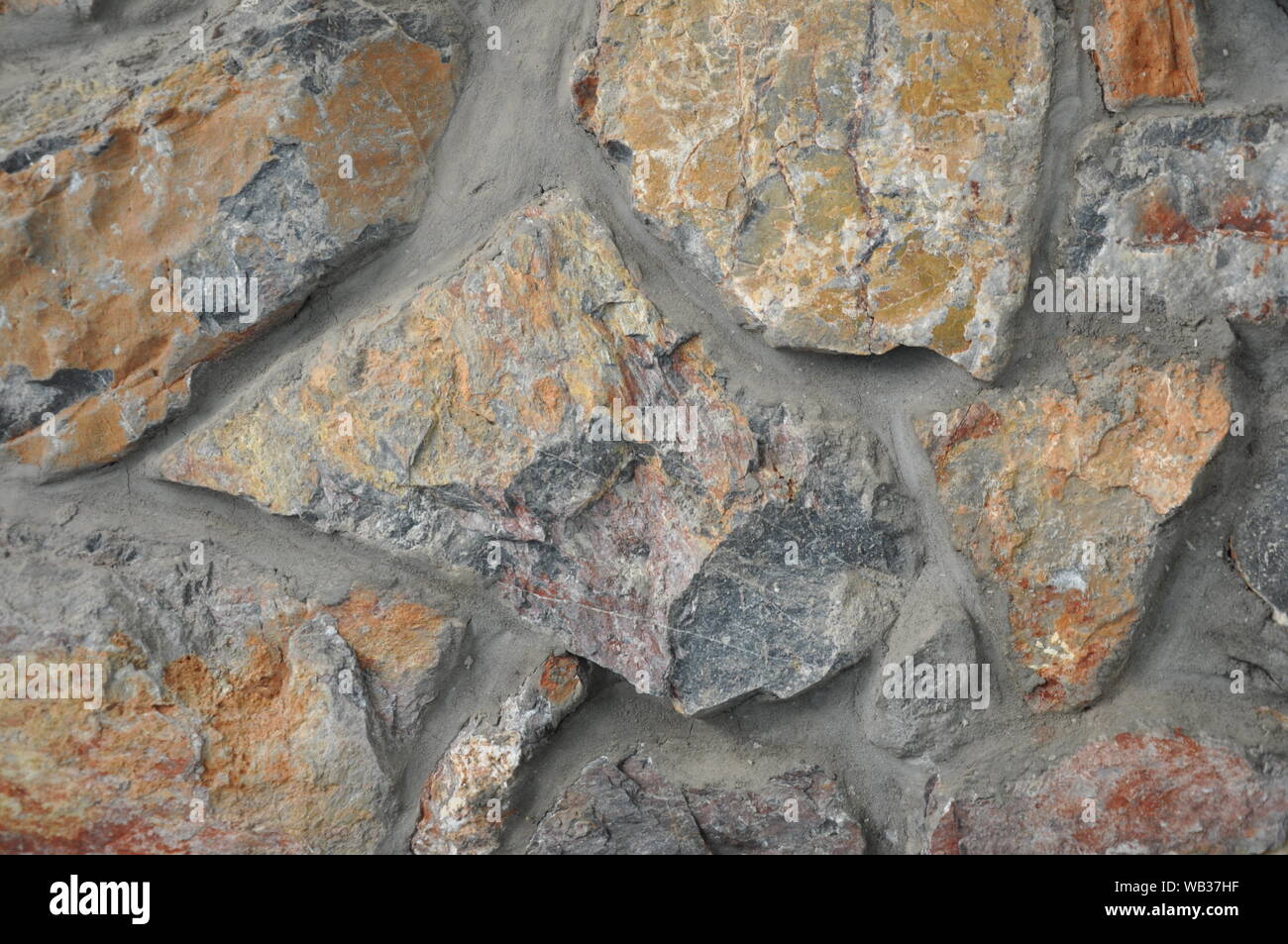 Wall made of natural stone with a red tint. Texture, background Stock ...