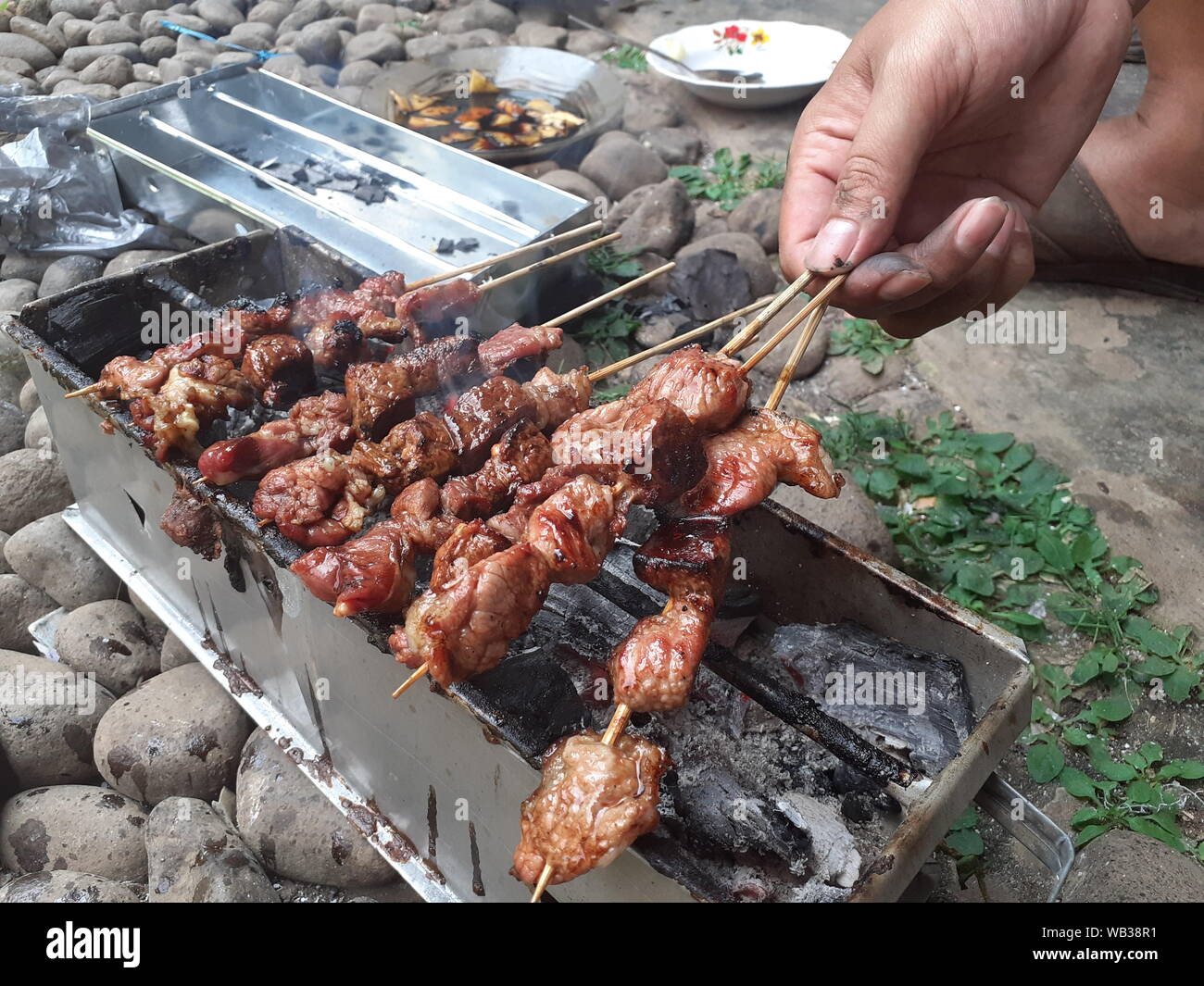 Indonesian traditional local food sate or satay on grill with smoke ...