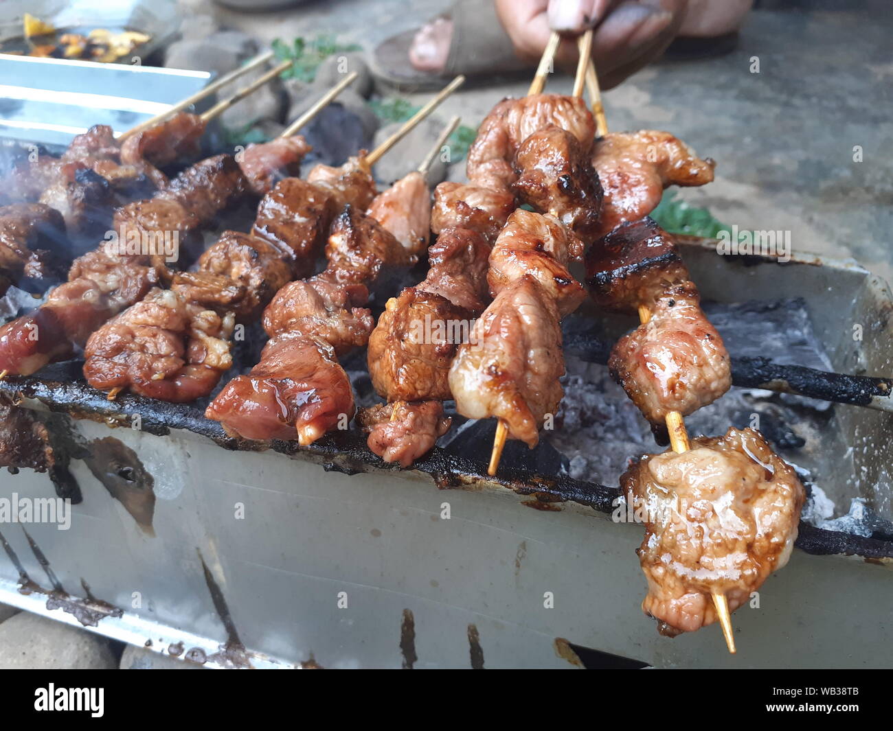 Indonesian traditional local food sate or satay on grill with smoke ...
