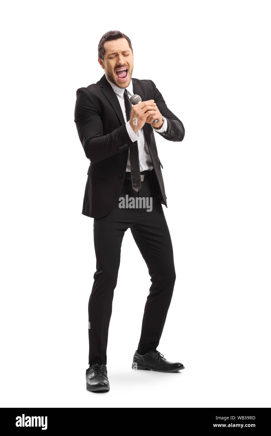 Full length portrait of a male singer with a microphone singing and ...