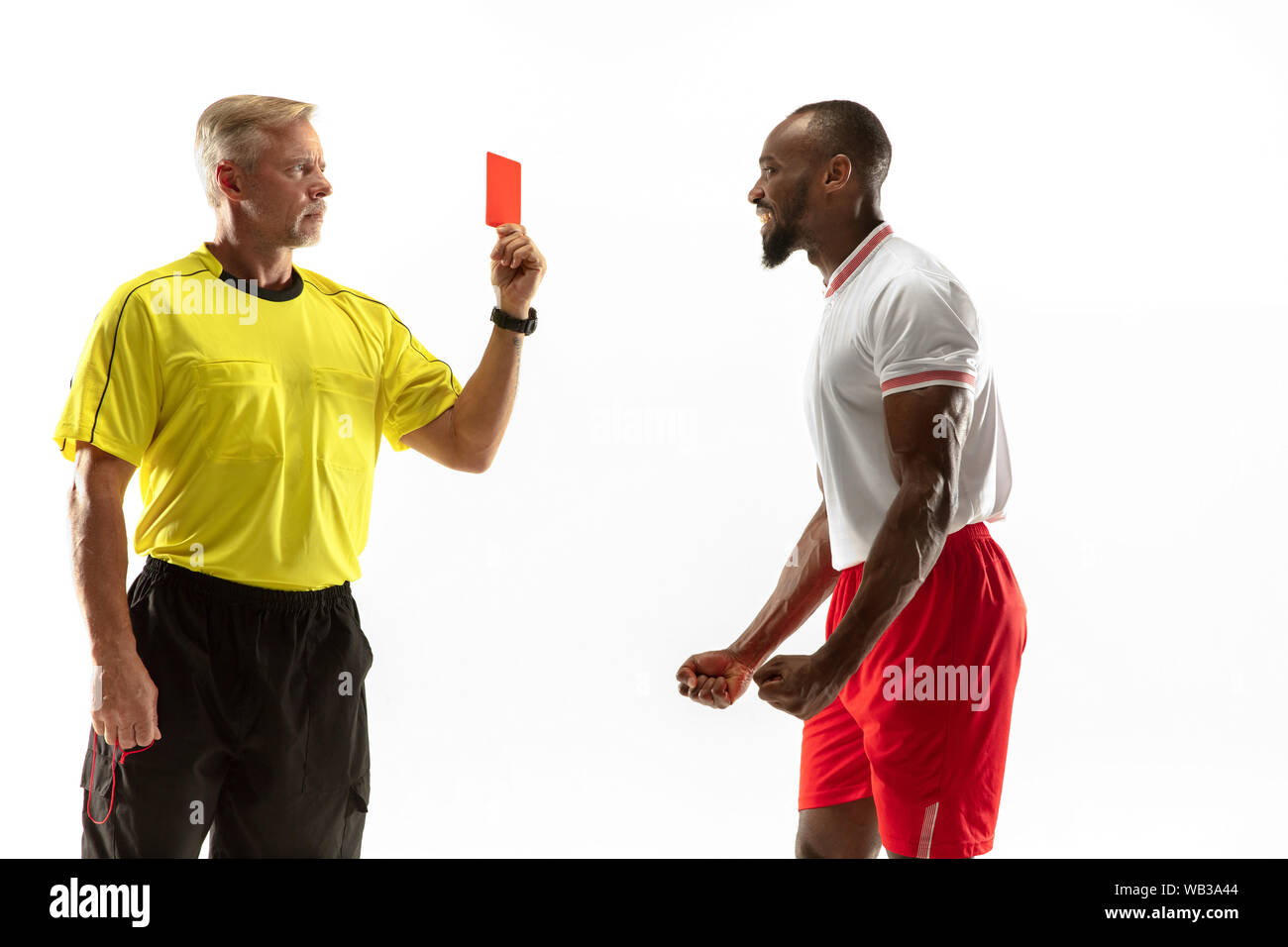 Referee showing a red card to a displeased african-american football or ...