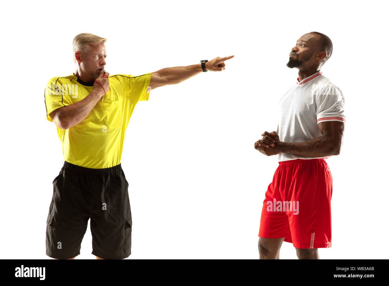 Referee gives directions with gestures to football or soccer players ...