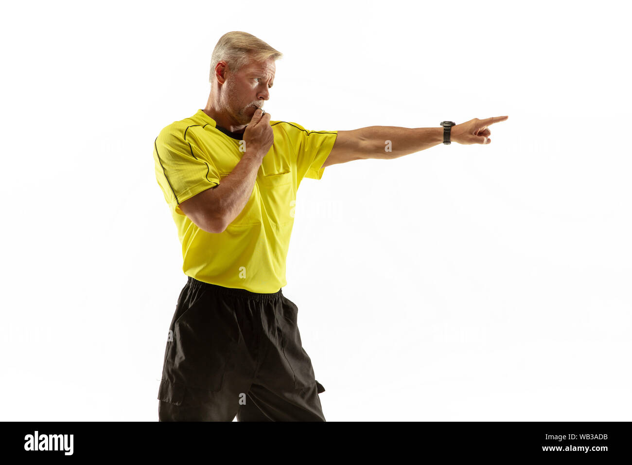 Referee gives directions with gestures to football or soccer players ...
