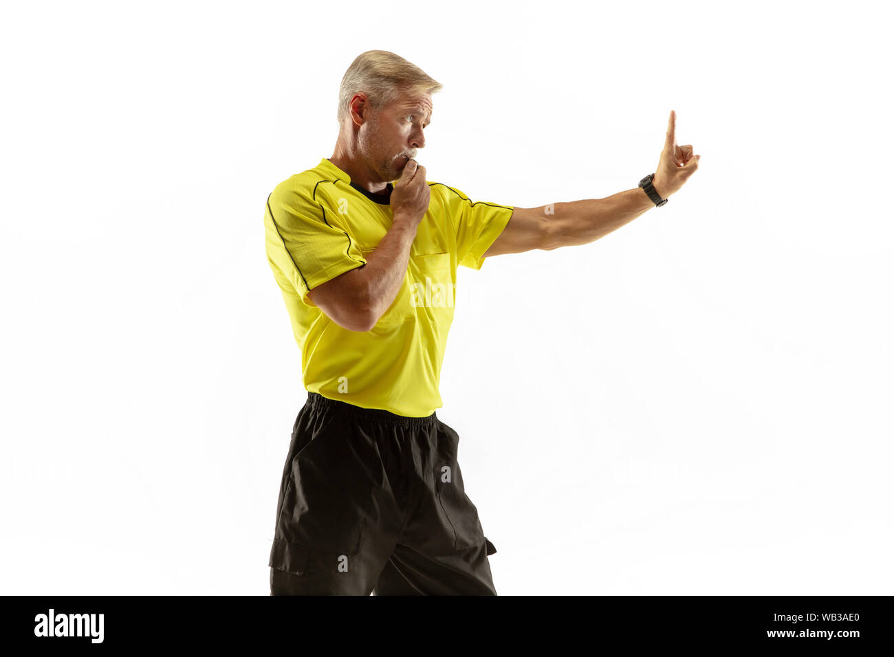 Referee gives directions with gestures to football or soccer players ...