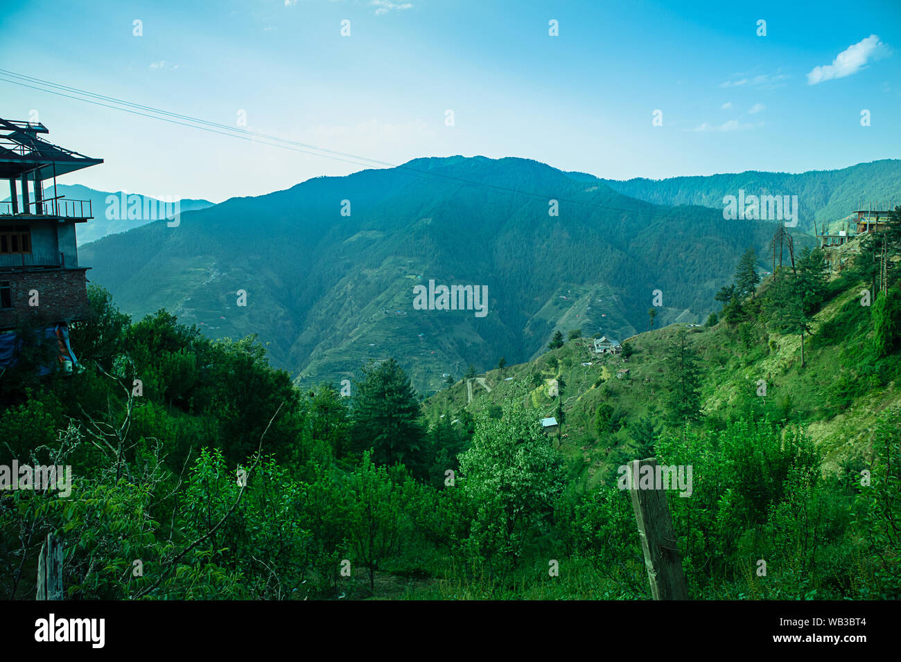 landscape of mountains with forest trees all around daytime Stock Photo ...