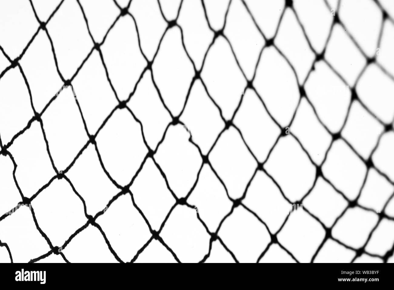 Square net shadow on white wall. Black and white image to overlay the ...