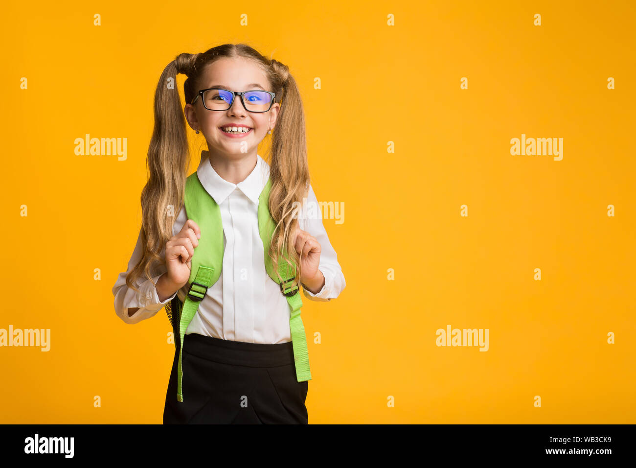 Cute First-Grade Elementary Student Smiling At Camera Over Yellow ...