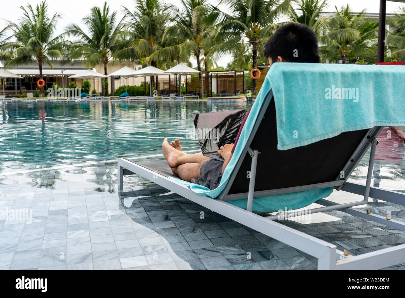 Using computer in swimming pool hi-res stock photography and images - Alamy