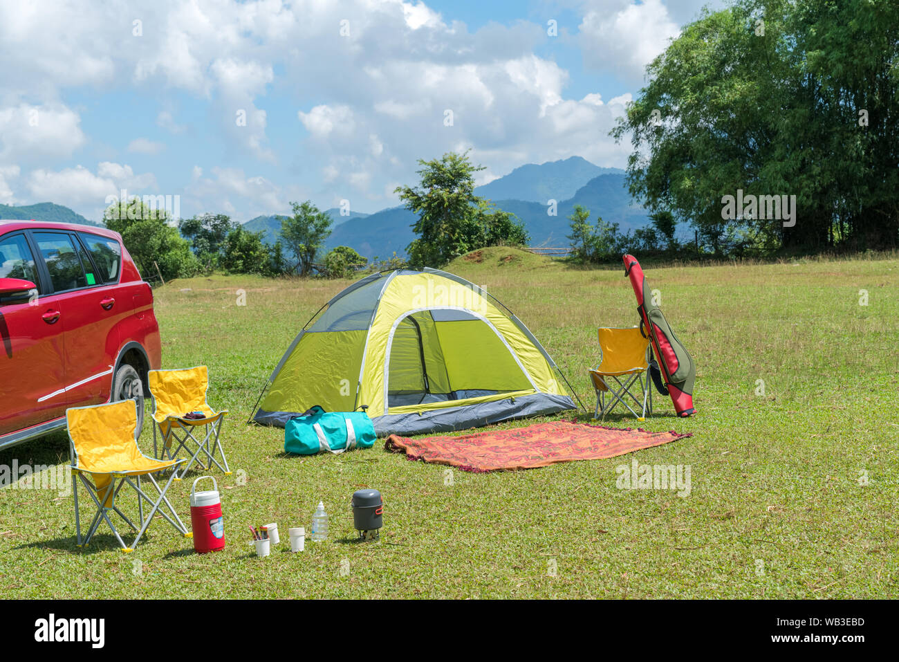 Camping site on grass field with tent and car beside tent. Leisure ...