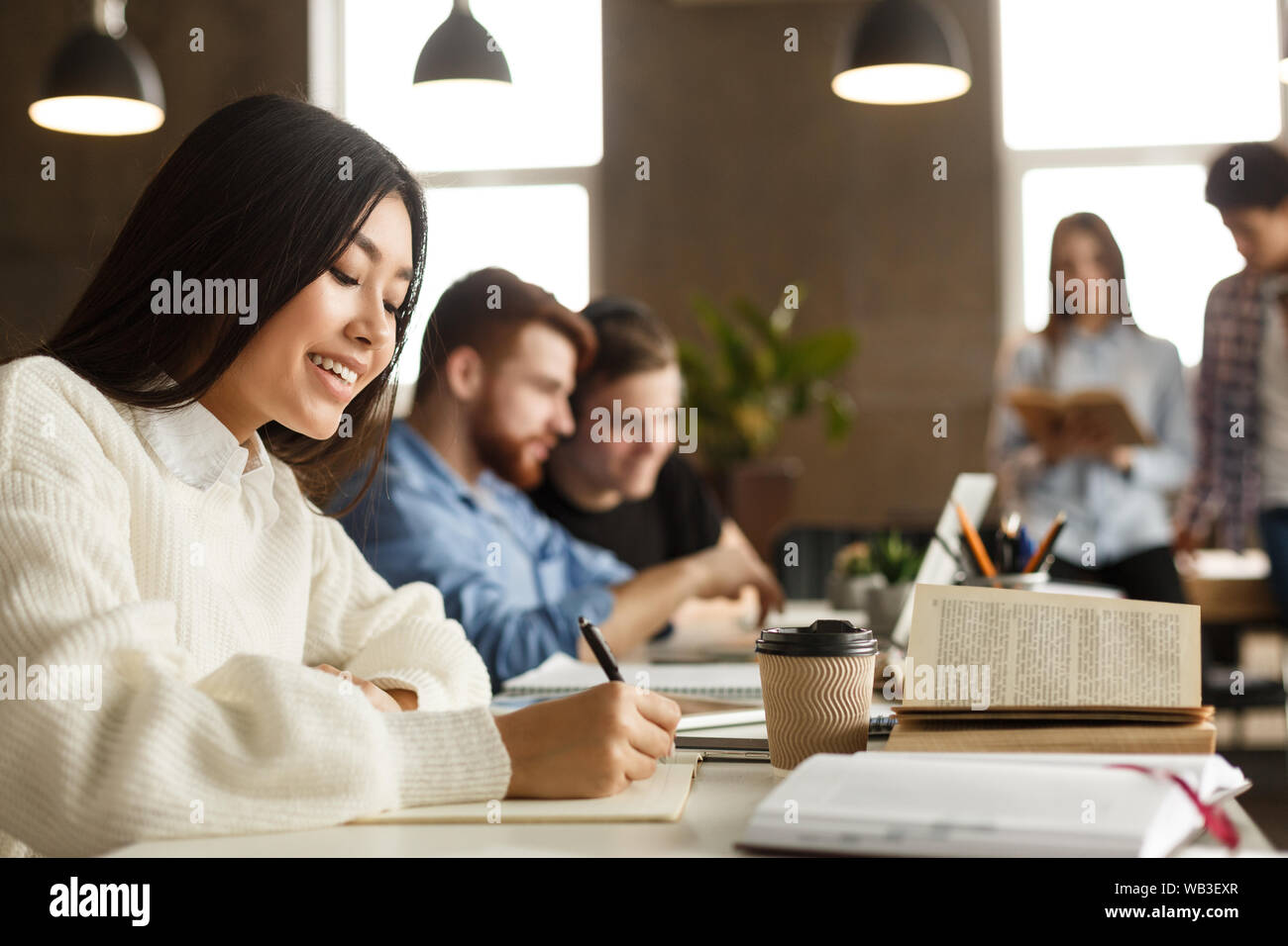 Asian teen girl writing library hi-res stock photography and images - Alamy