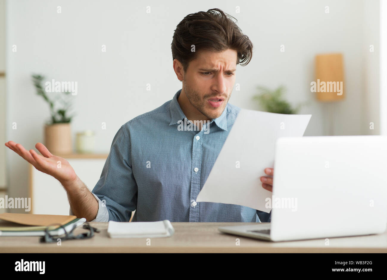 Confused Guy Reading Mail Letter Or Debt Notification Indoors Stock ...