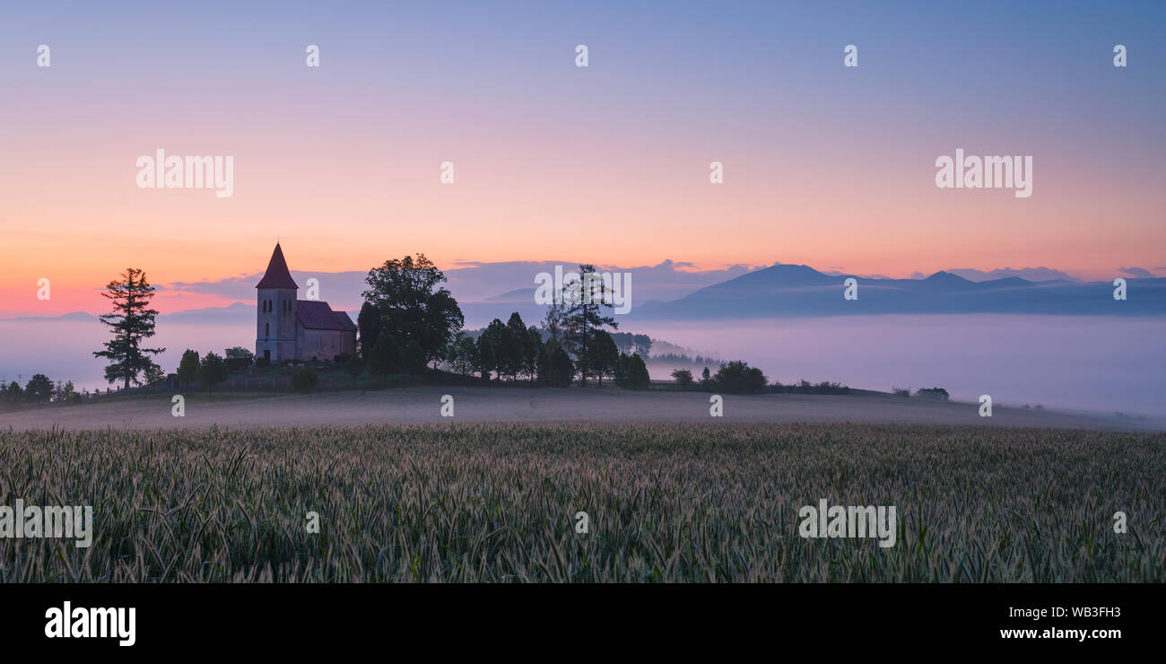 Rural Gothic church in a cemetery on a foggy morning Stock Photo - Alamy