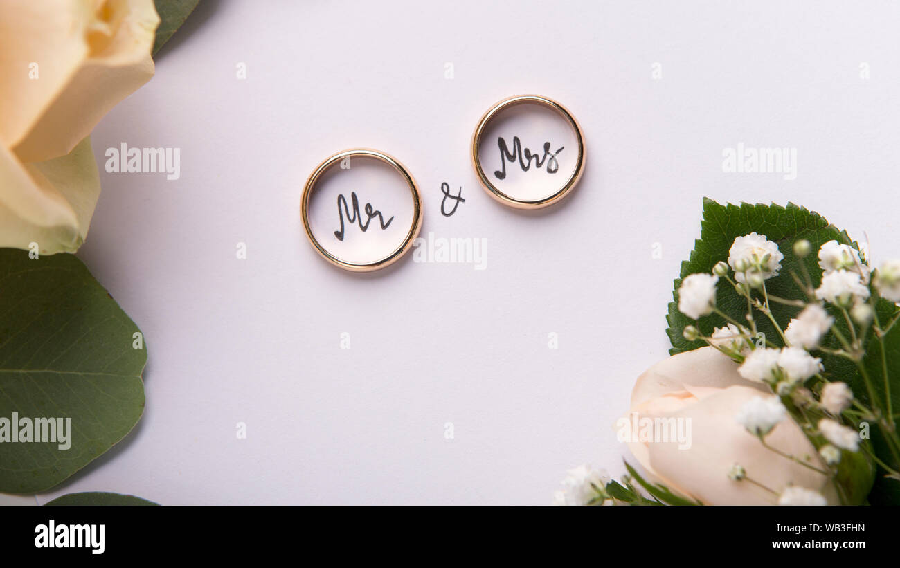 Creative Wedding rings mr and mrs on white background Stock Photo - Alamy