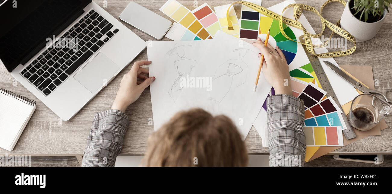 Dressmaker drawing sketches, designing new collection. top view Stock ...