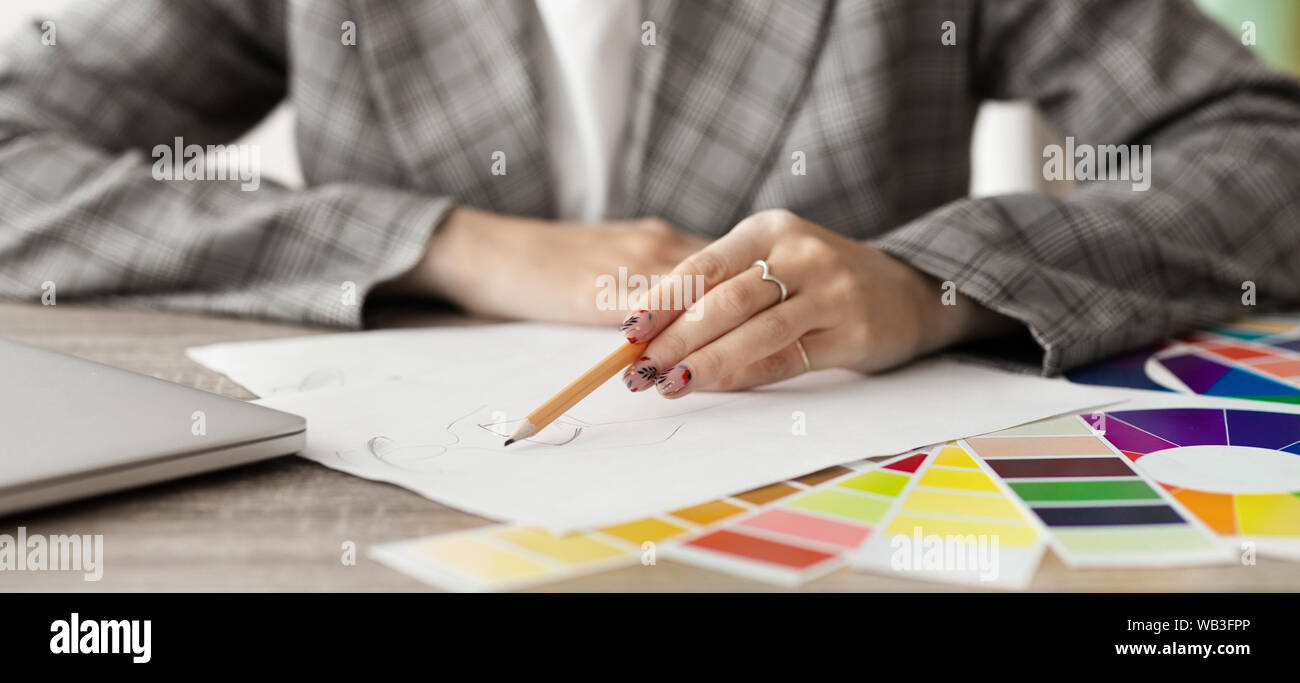 Fashion designer working on drawing sketches for clothes Stock Photo ...
