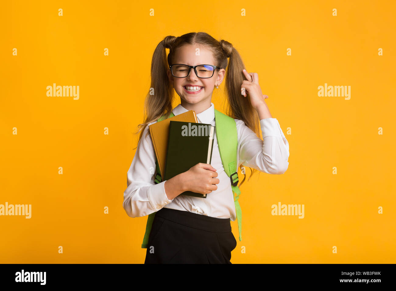 Cute First-Grade Student Girl Keeping Fingers Crossed On Yellow ...