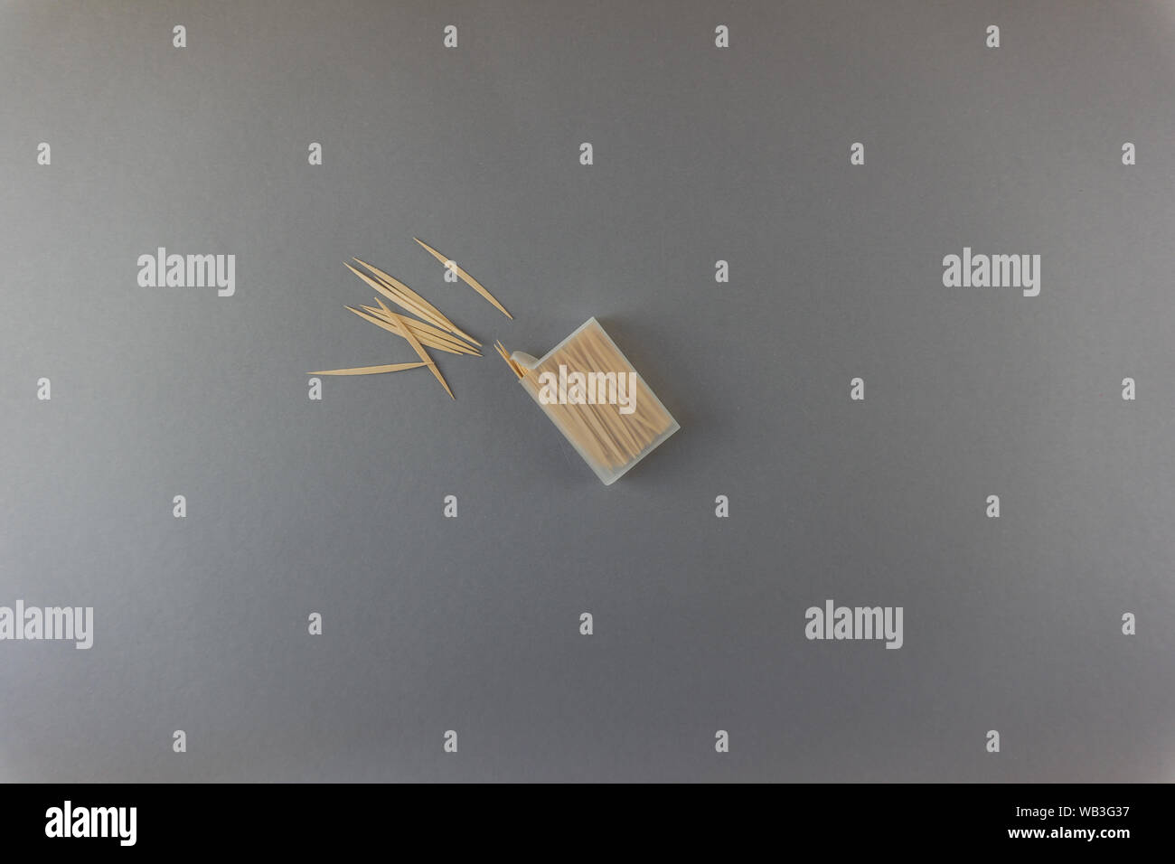 Messy arranged toothpicks with box on gray background Stock Photo - Alamy