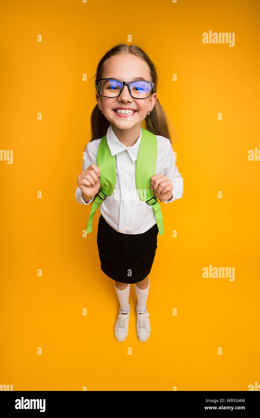 Happy Elementary School Girl In Eyewear Smiling At Camera High-Angle ...