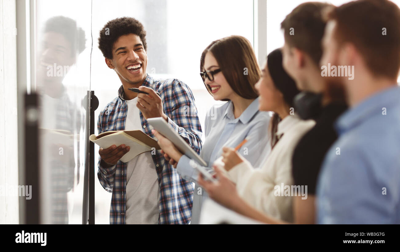High school friends laughing, solving problems on whiteboard Stock ...