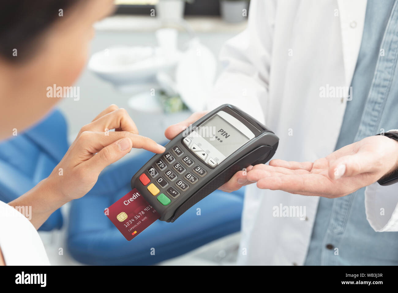 Doctor is holding payment terminal in hands. Paying for health care ...