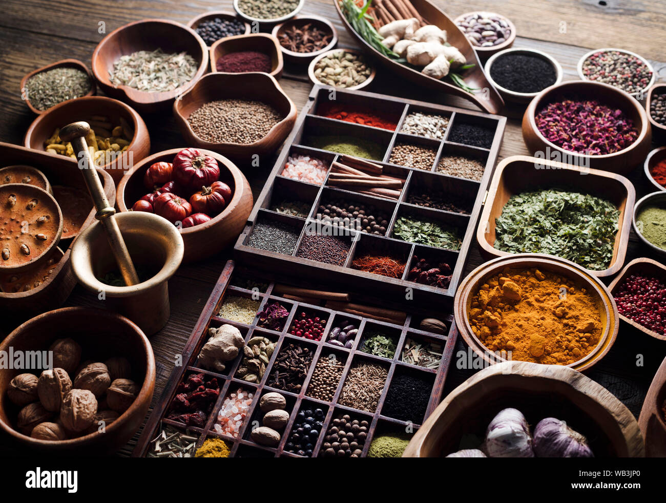 Collection of spices in bowls on wooden rustic table. Place for text or ...