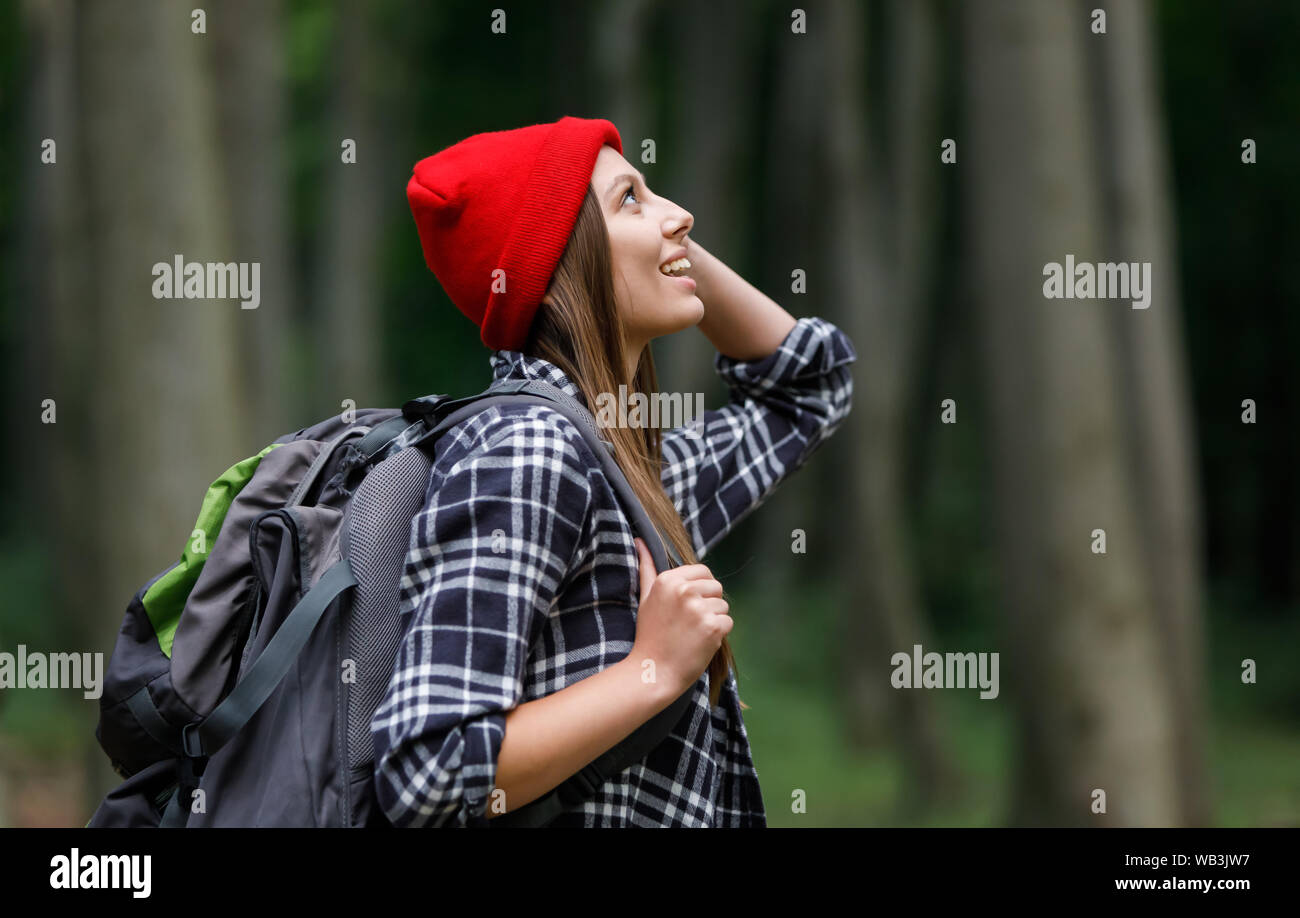 View of active woman dressed in casual clothes admiring of the forest ...