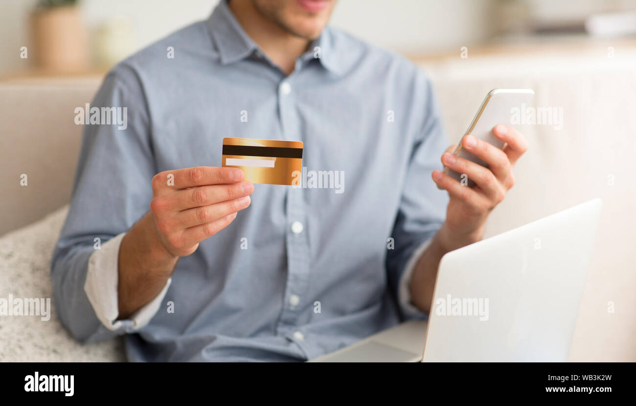 Unrecognizable Guy Holding Credit Card And Phone Sitting On Sofa Stock ...