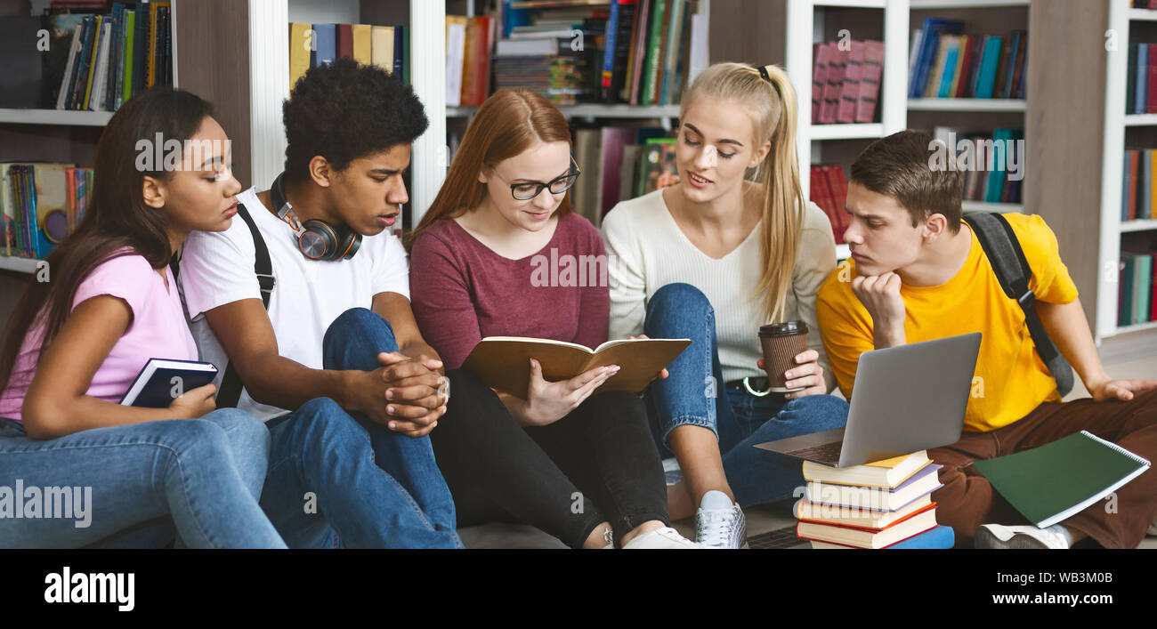 Smart girl reading report to other students Stock Photo - Alamy