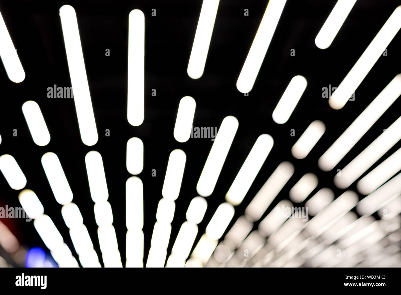 Abstract blurred white neon led light lamp stripes on ceiling ...
