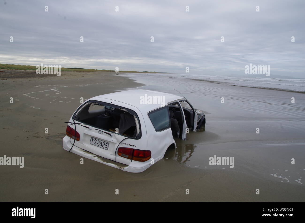 Abandoned sunken car wreck in Quicksand. Te Araroa Trail. Otatara beach ...