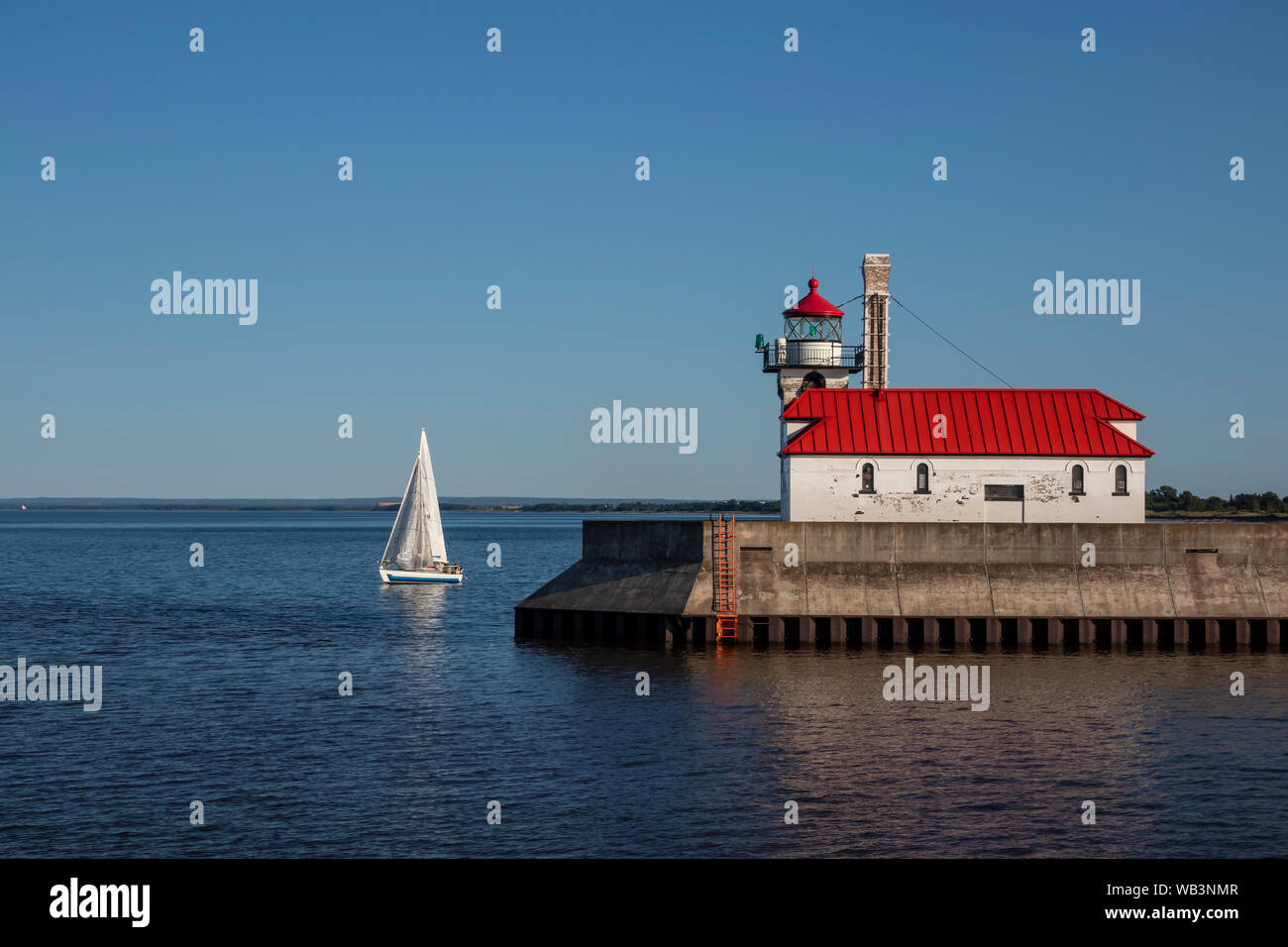 Lake Superior Breakwater Lighthouse with Sailboat Stock Photo - Alamy