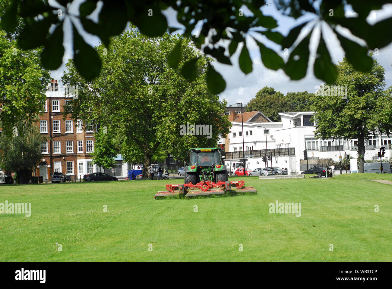 Cutting the grass at Peckham Common in spring Stock Photo - Alamy