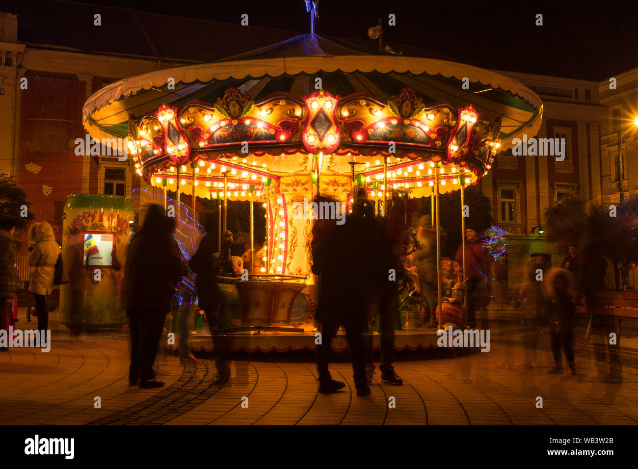 View of a spinning carousel for kids. Night scene. Long exposure Stock ...