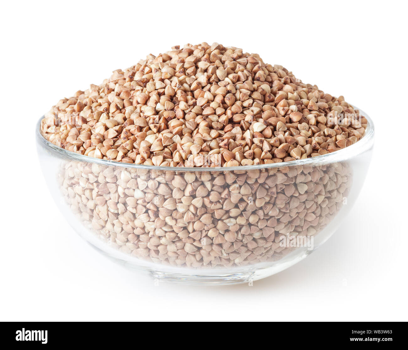 Roasted buckwheat grains in glass bowl isolated on white background ...