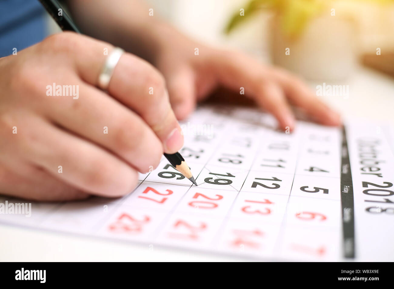 Picture of Man holding Calendar and marking on a date. Isolated on ...