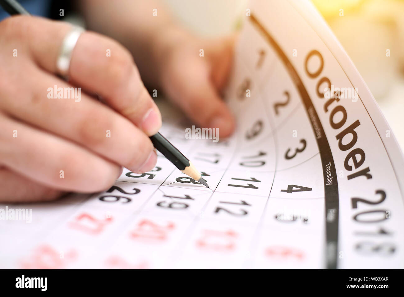 Picture of Man holding Calendar and marking on a date. Isolated on ...