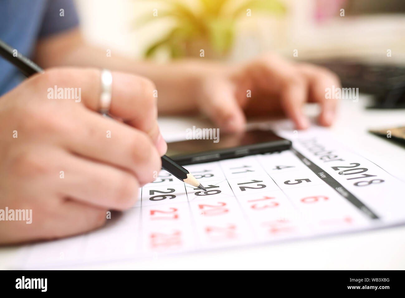 Picture of Man holding Calendar and marking on a date. Isolated on ...