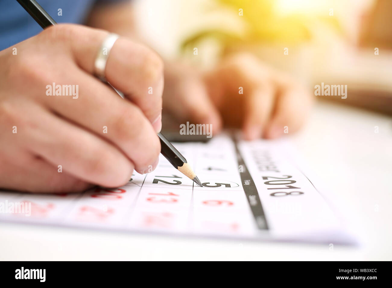 Picture of Man holding Calendar and marking on a date. Isolated on ...