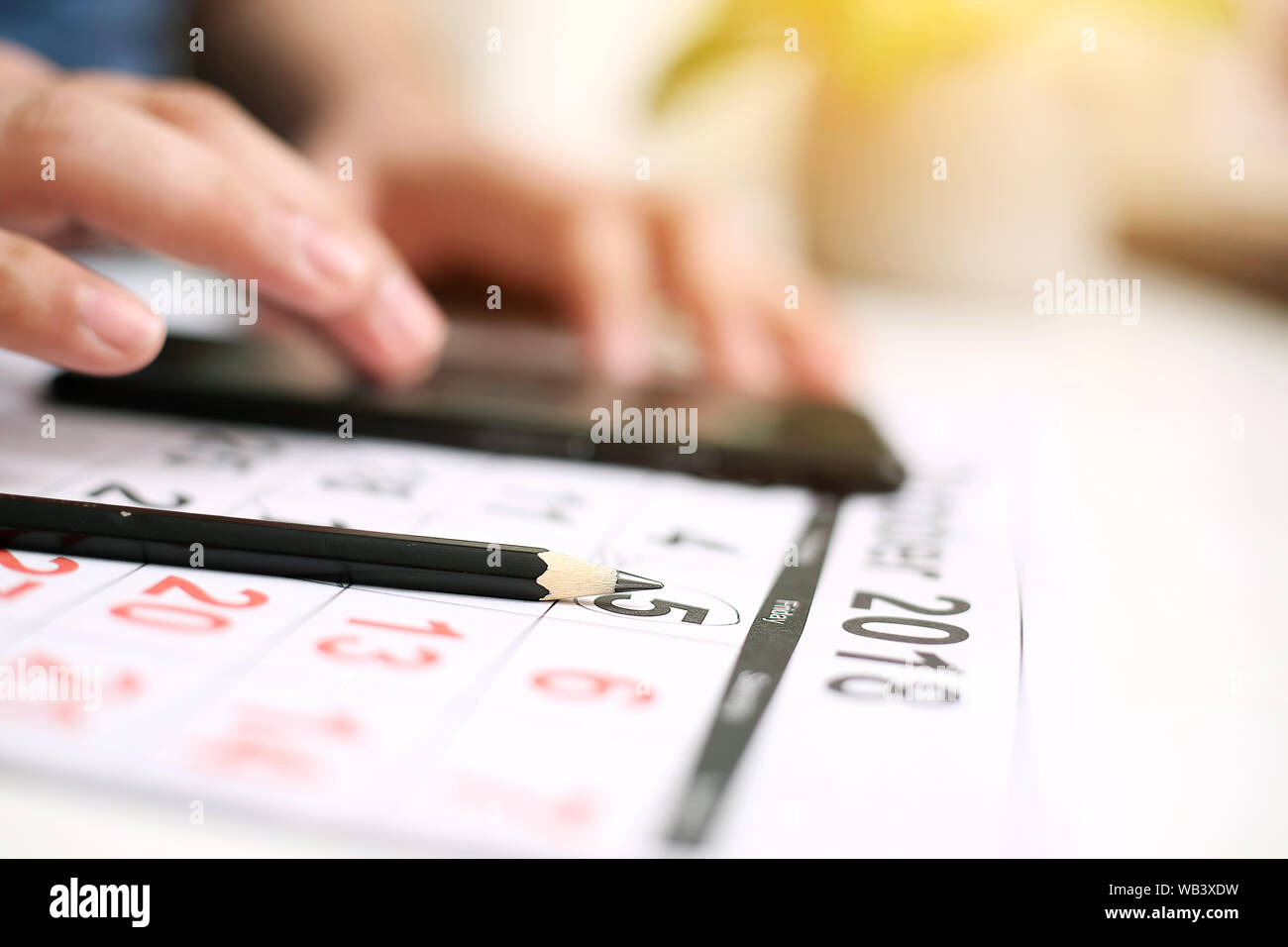 Picture of Man holding Calendar and marking on a date. Isolated on ...