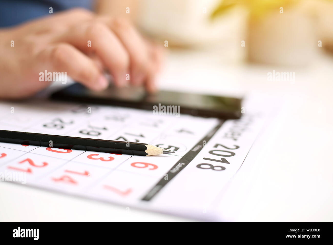 Picture of Man holding Calendar and marking on a date. Isolated on ...