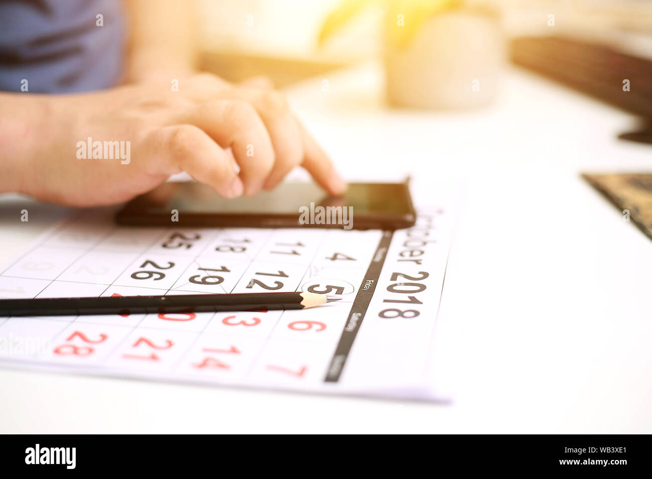 Picture of Man holding Calendar and marking on a date. Isolated on ...