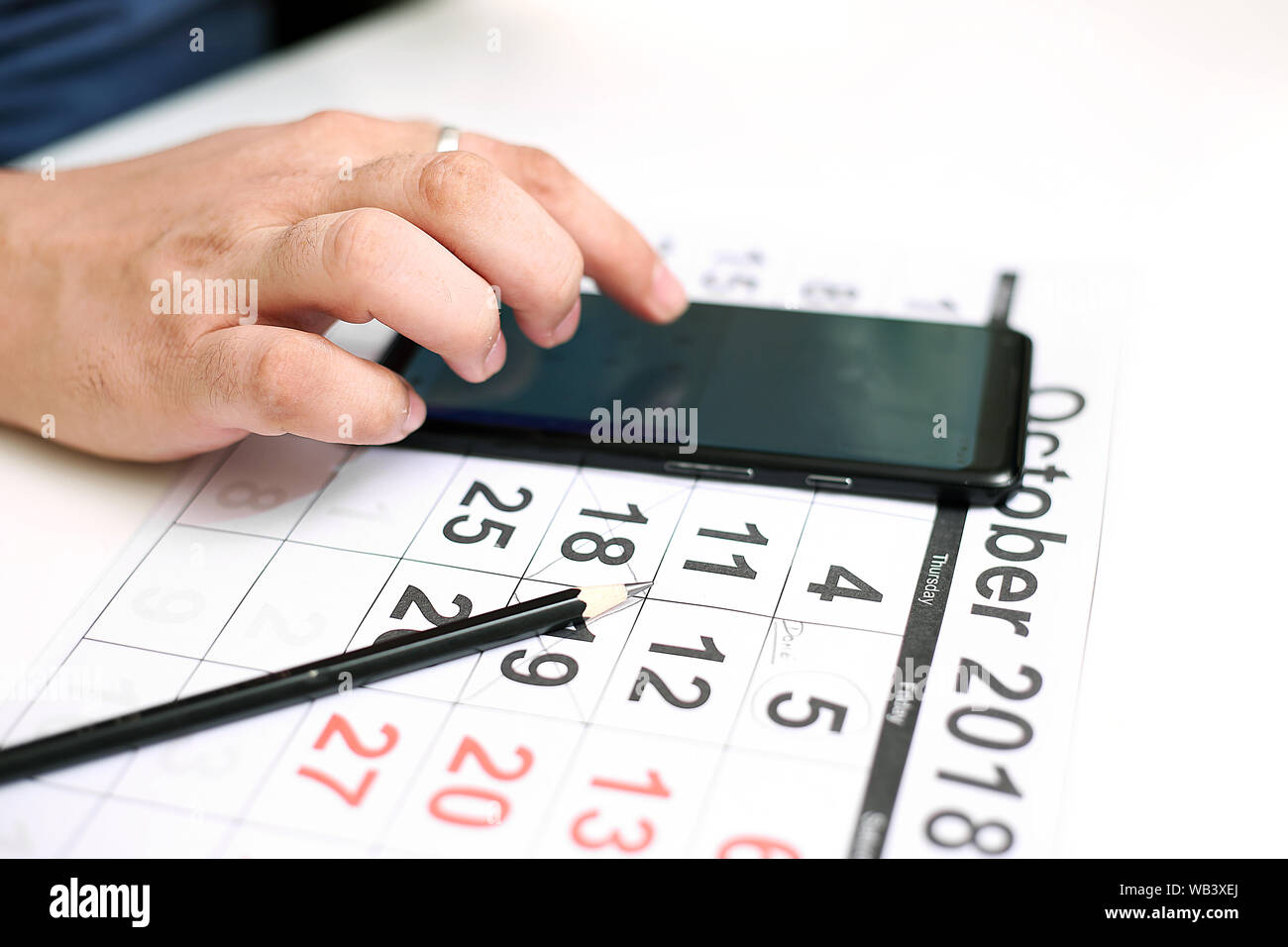 Picture of Man holding Calendar and marking on a date. Isolated on ...