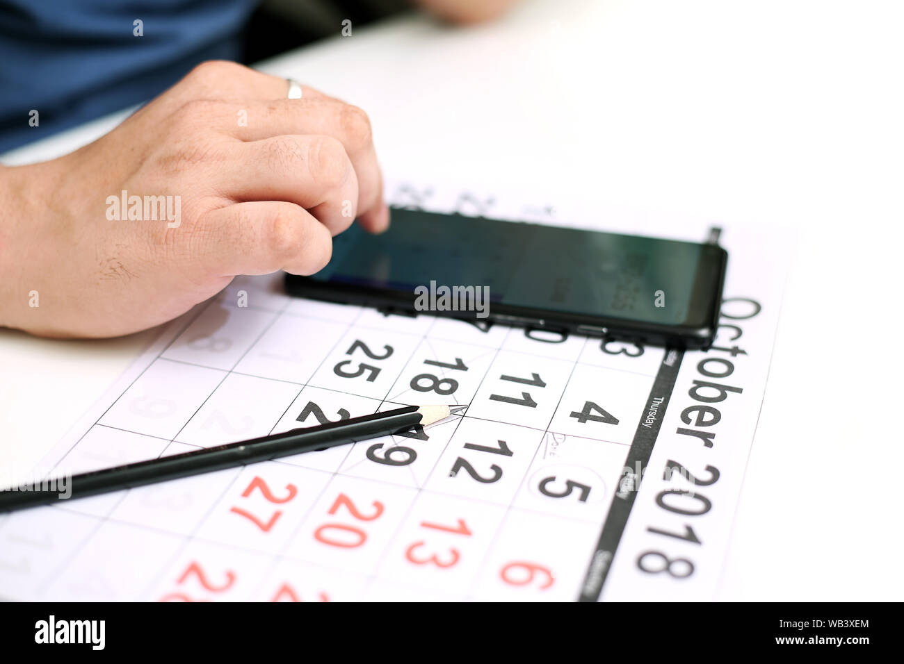 Picture of Man holding Calendar and marking on a date. Isolated on ...